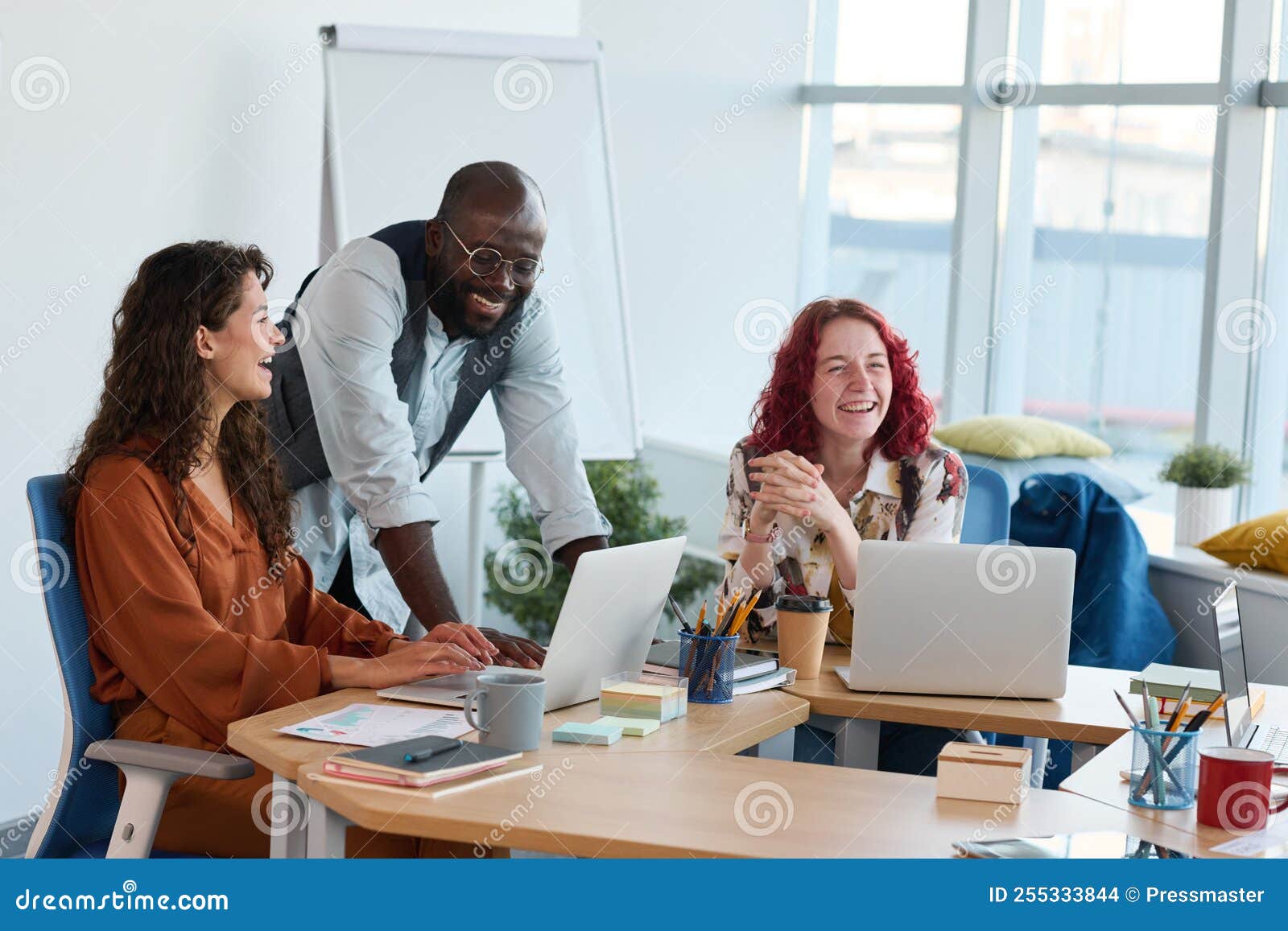 Three Young Multicultural Employees Laughing at Working Meeting in ...
