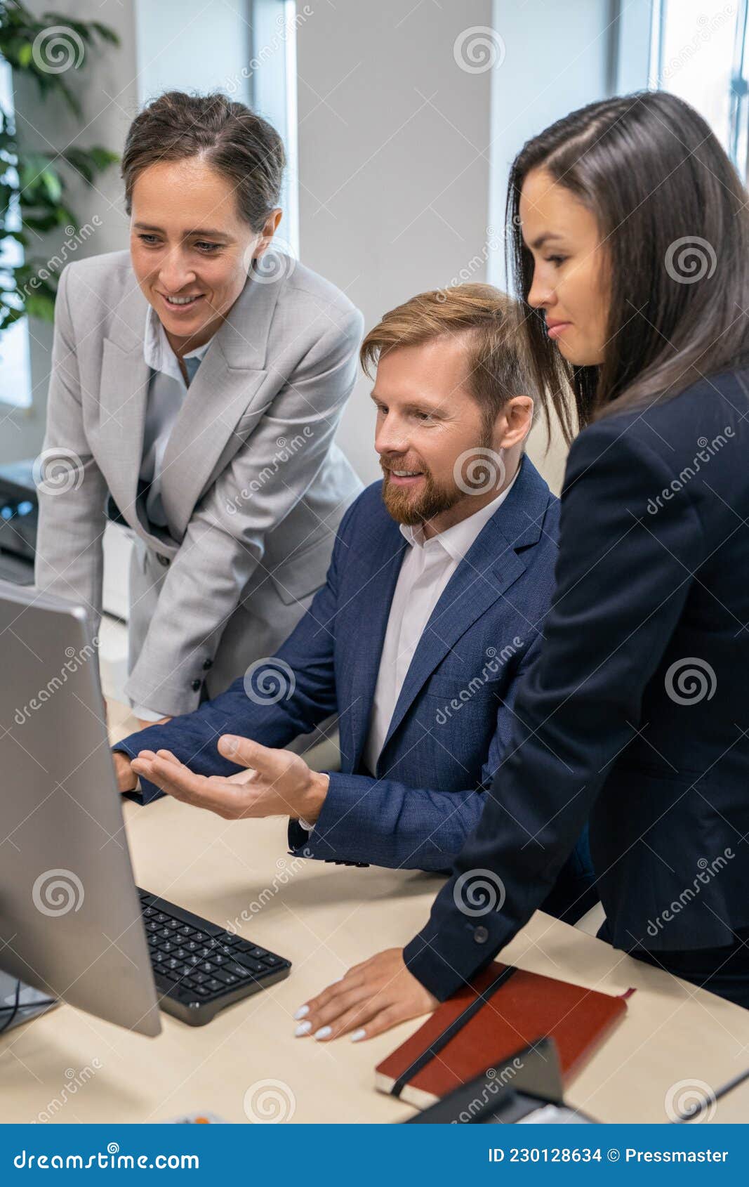 Three Young Office Workers Looking at Computer Screen Stock Photo ...