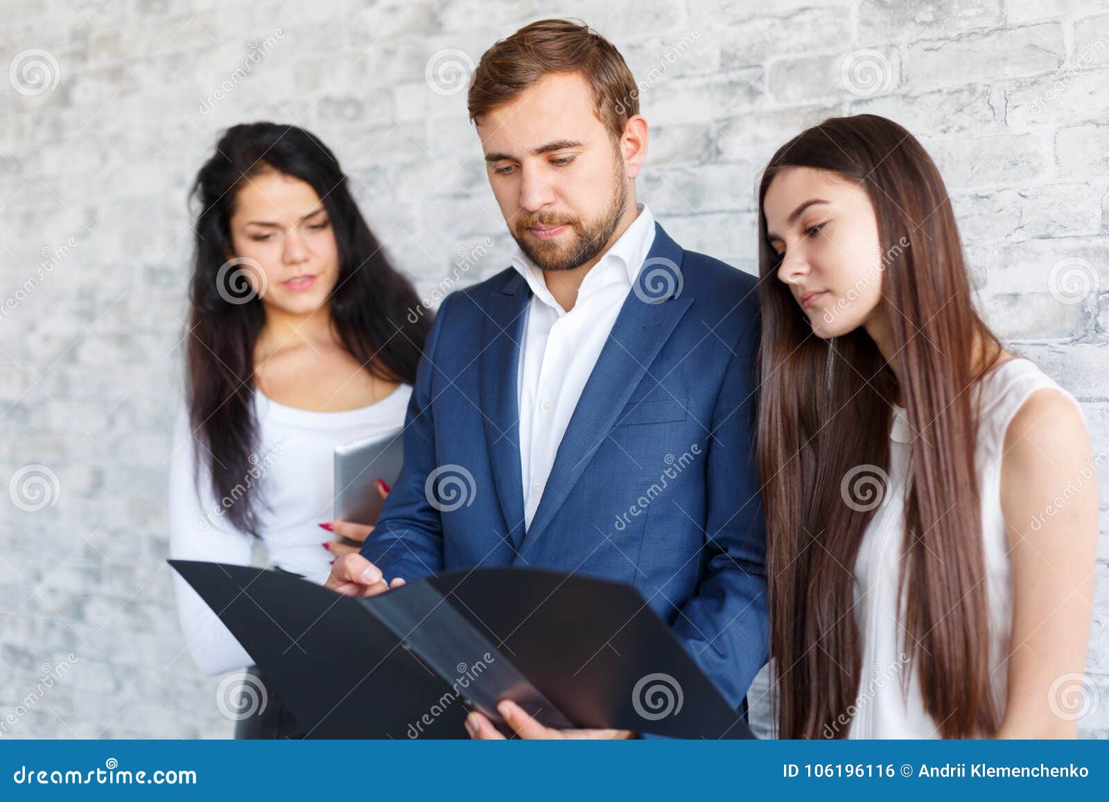 Three Office Workers, are Examining Something in a Folder with ...