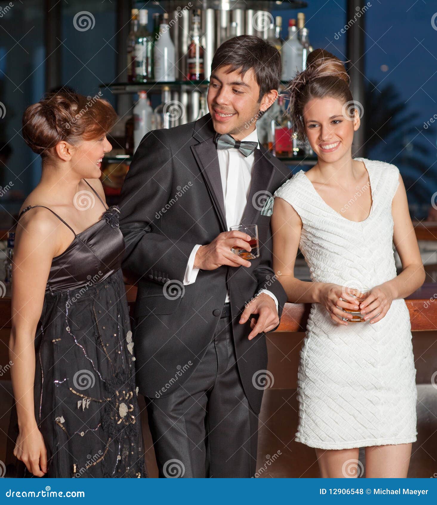 Three Young People at Bar Drinking and Flirting Stock Photo - Image of ...