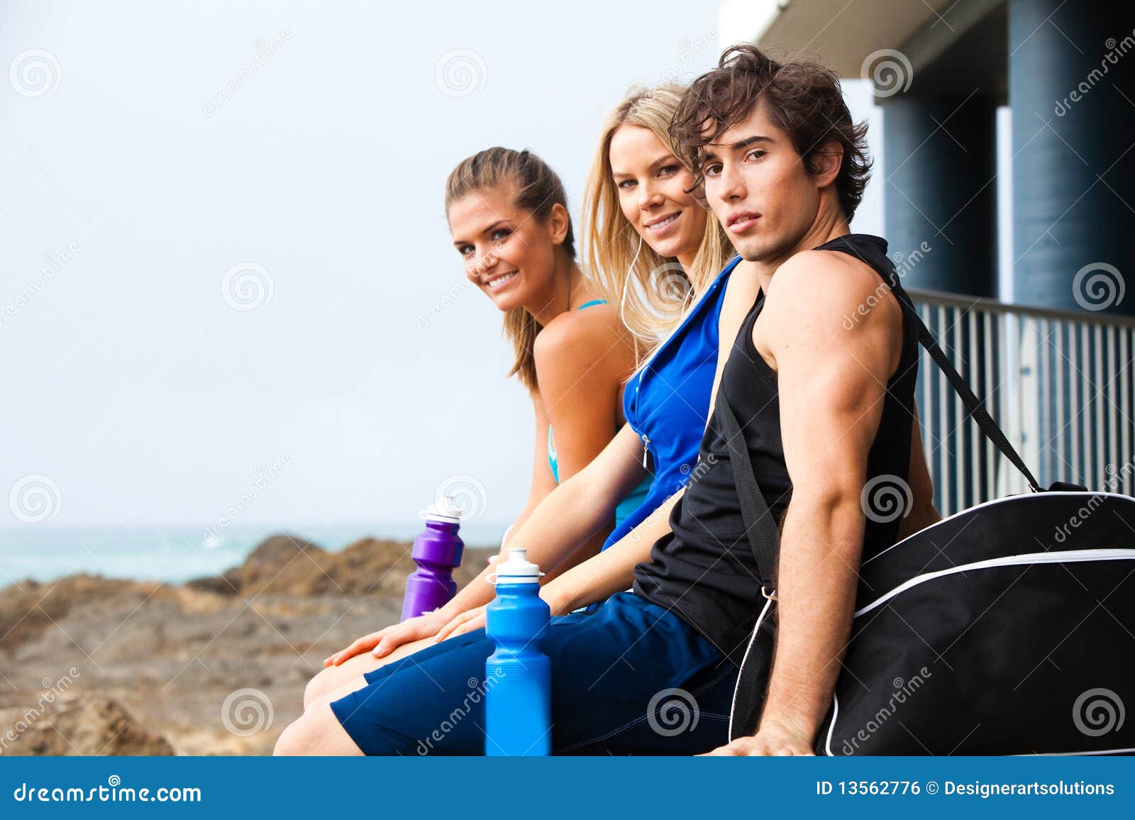 Three Young People at the Beach Stock Photo - Image of male, leisure ...