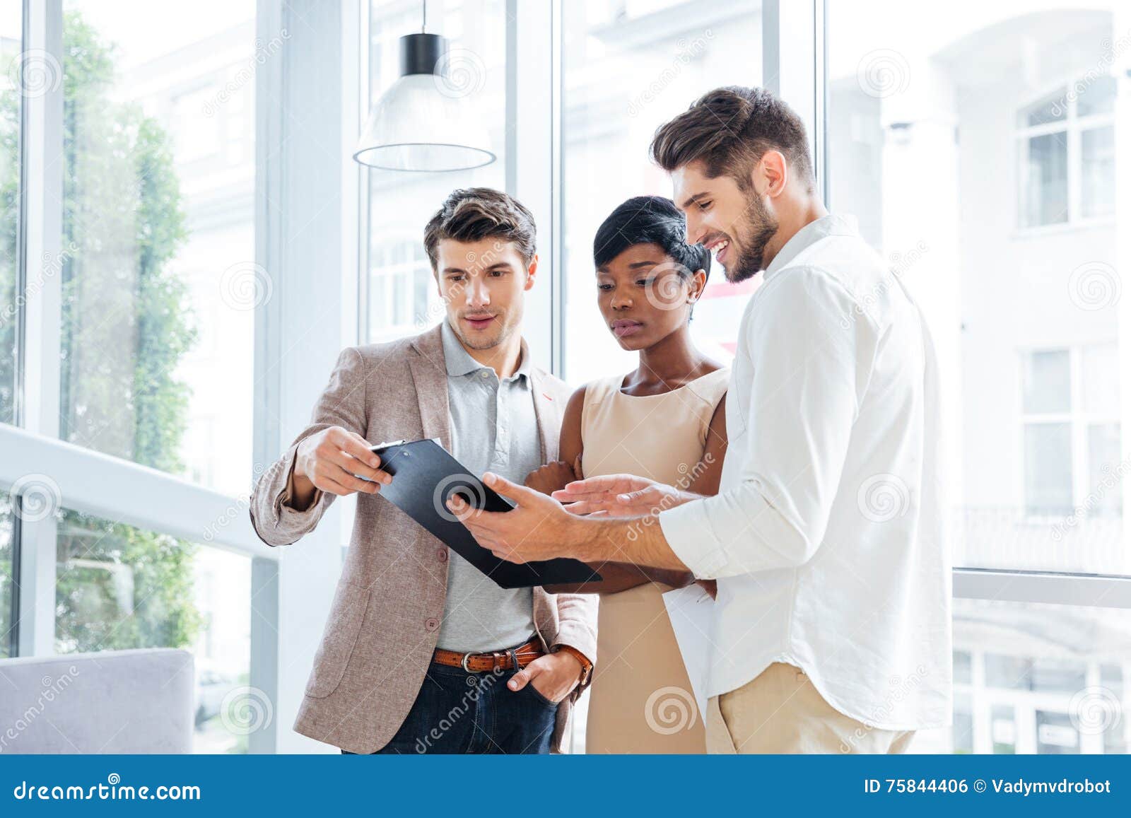 Three Young People Discussing Business Plan Together in Office Stock ...