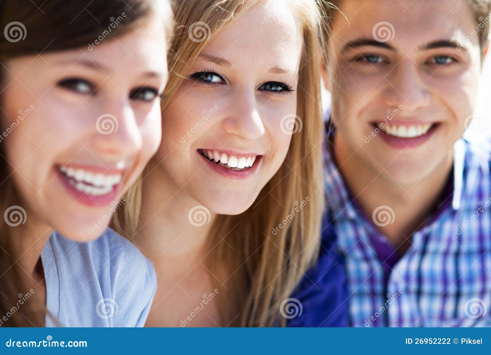 Three young people smiling stock photo. Image of three - 26952222