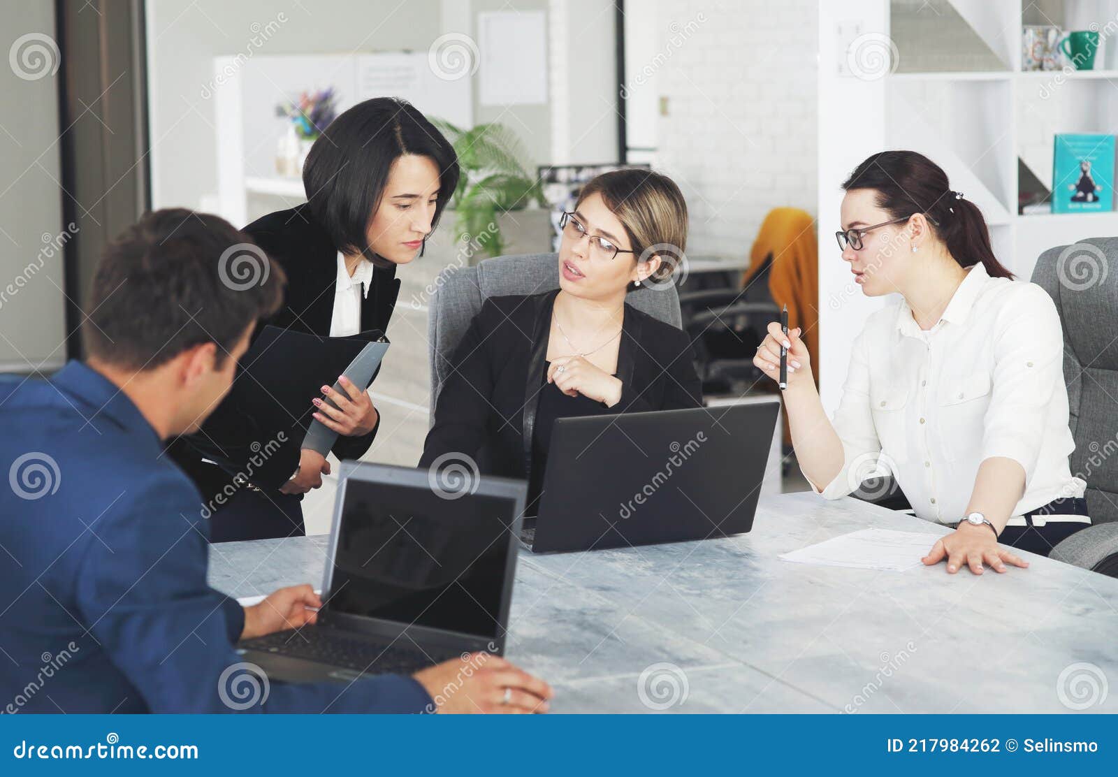 Three Young Successful Business Women in the Office Working Together on ...