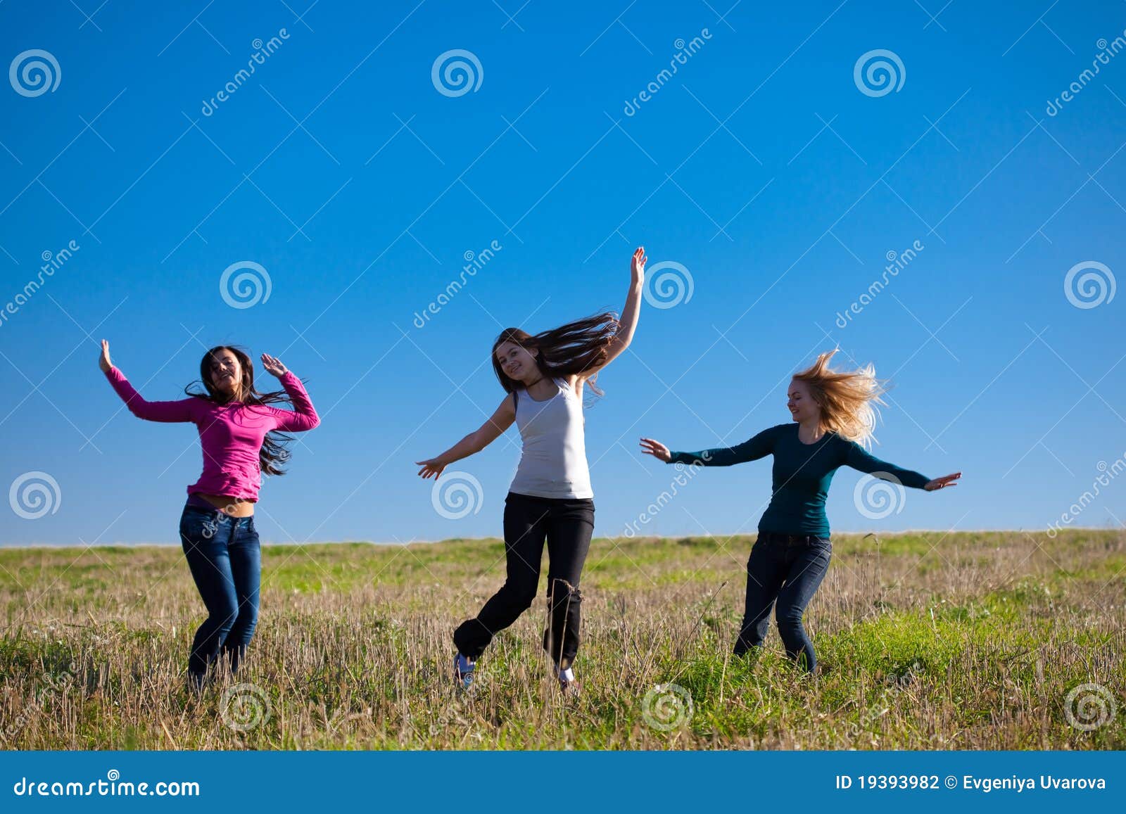 Three Young Woman Jumping into the Field Stock Photo - Image of ...