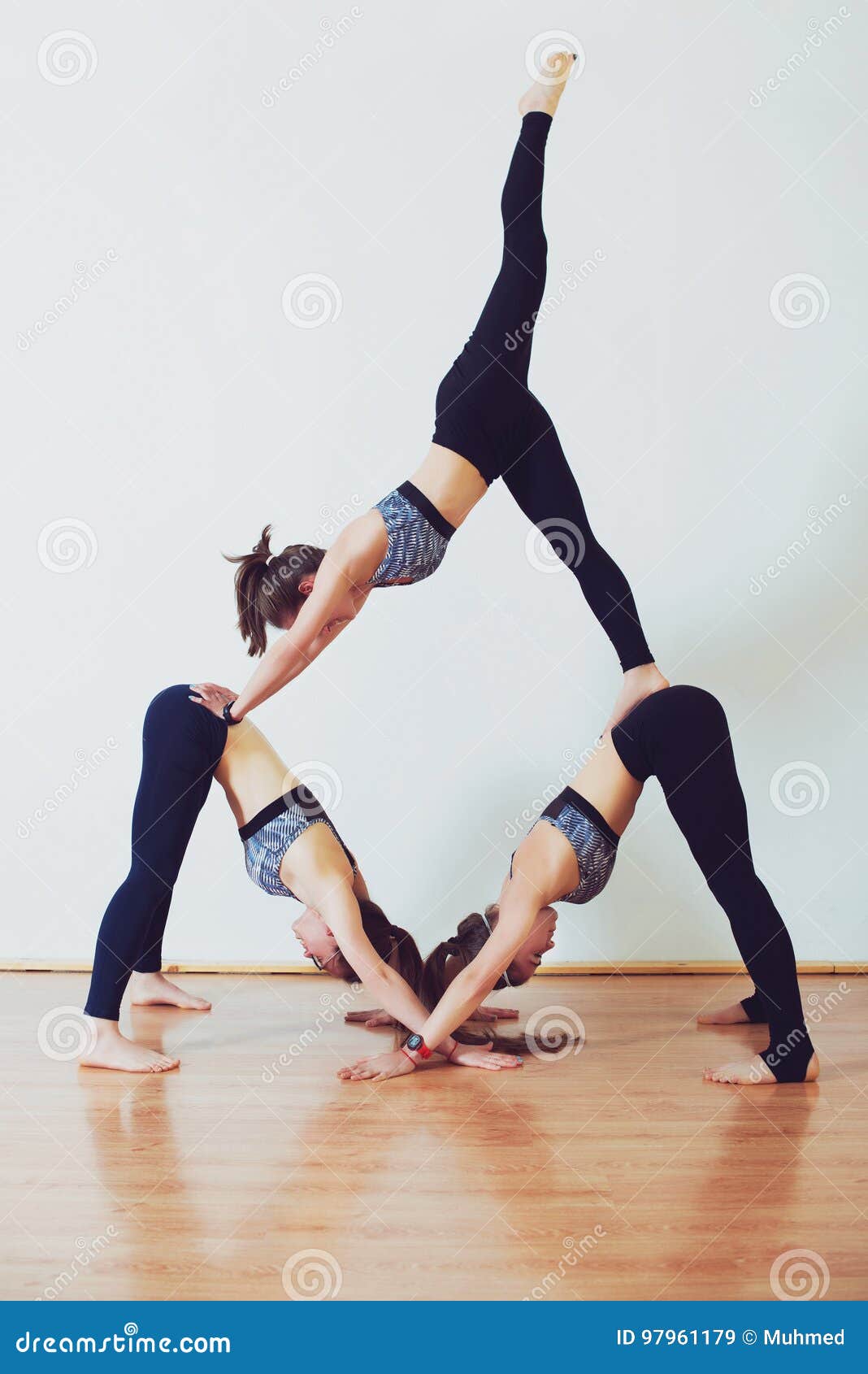 Three Young Women Practicing Acro Yoga in White Studio. Stock Image ...