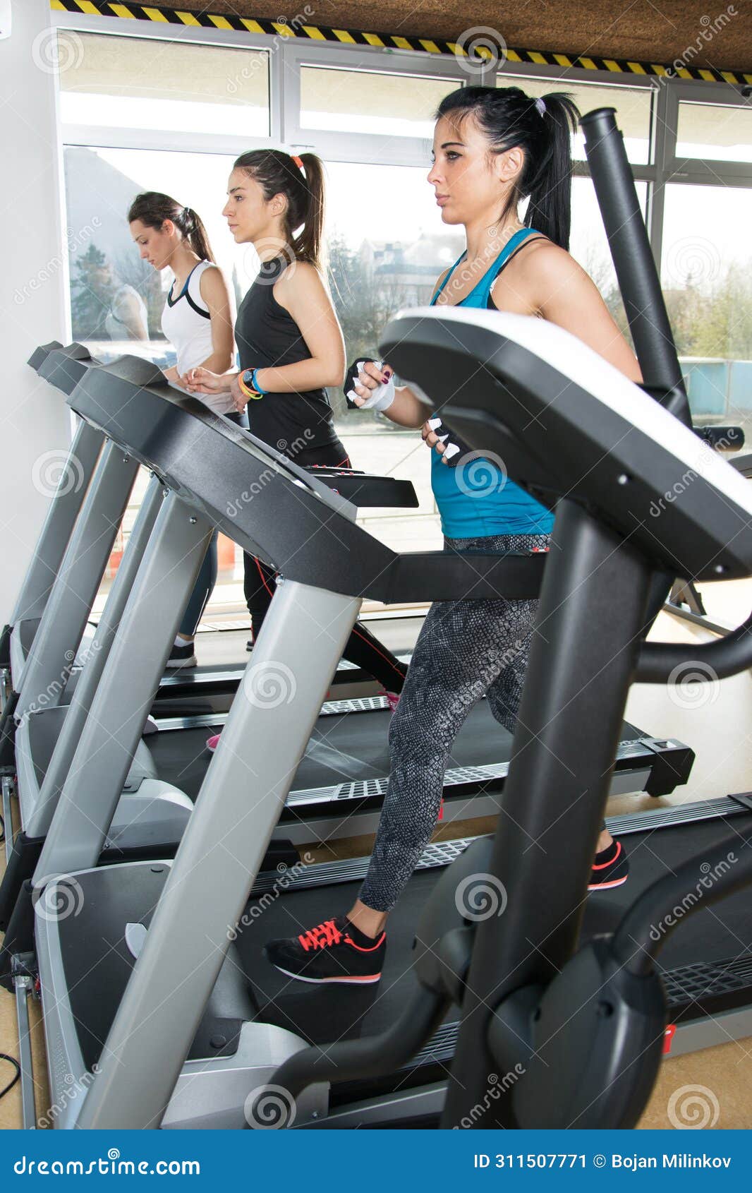 Three Young Women Running on Treadmill in Gym Stock Image - Image of ...