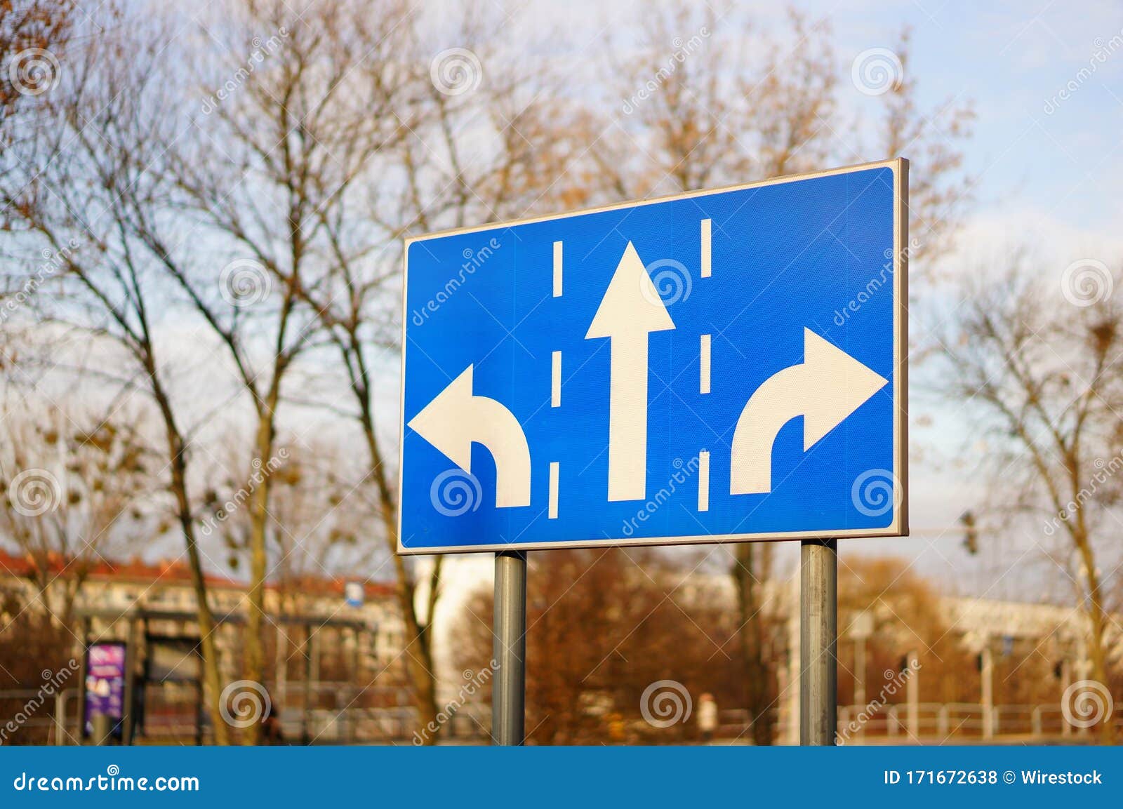 Threeway Blue Sign on the Side of a Road at Daytime Stock Photo - Image ...