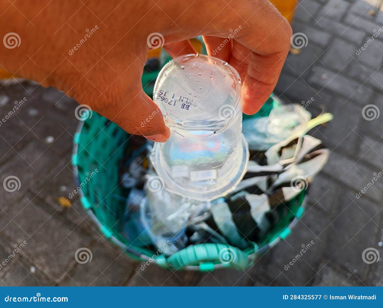 Throw Plastic Cup Waste into the Trash with Your Left Hand Stock Image ...
