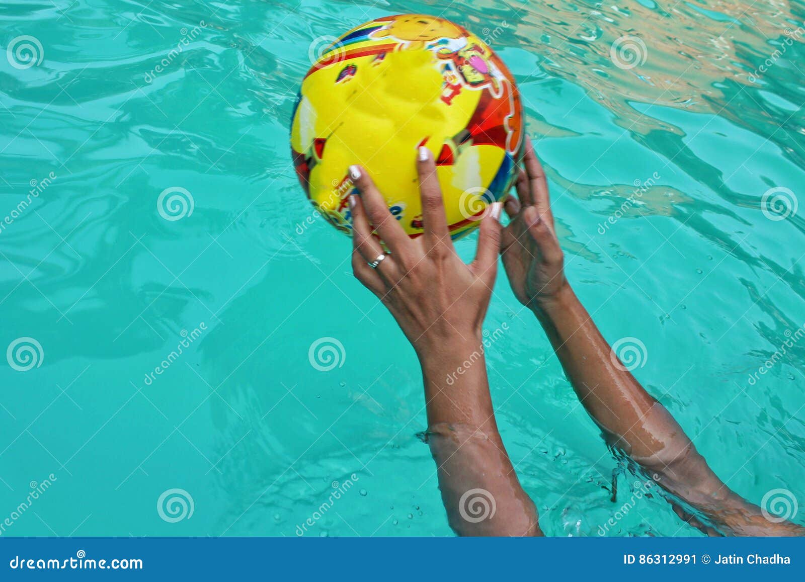 Throwing Ball in the pool stock image. Image of balls - 86312991