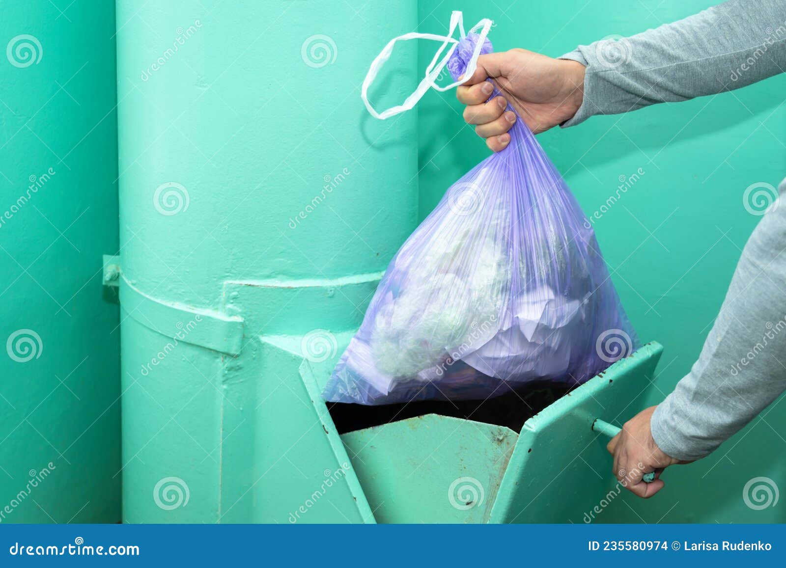 Throwing Garbage into the Garbage Chute, a Man`s Hand with a Garbage ...