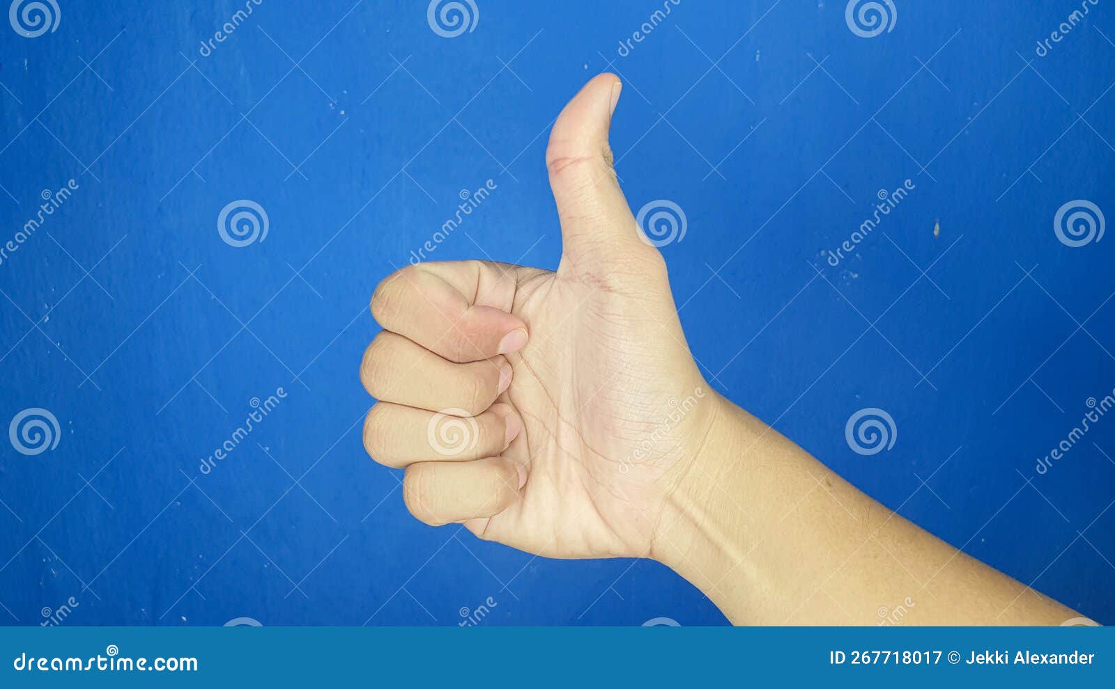 Thumb Up Sign with Hand and a Blue Background Stock Image - Image of ...