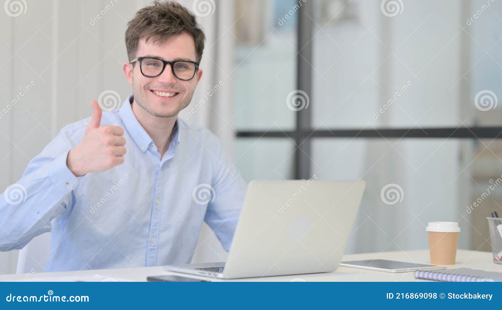 Thumbs Up by Young Man with Laptop at Work Stock Photo - Image of ...