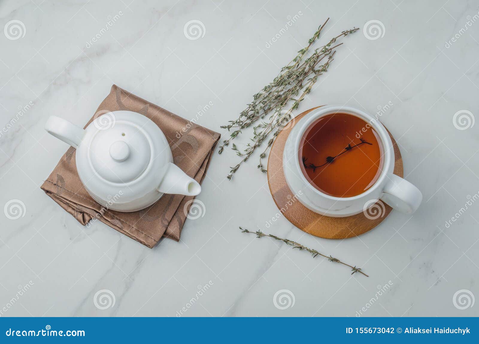 Thyme Herbal Tea, View from High Angle on White Cup with Tea and Kettle ...