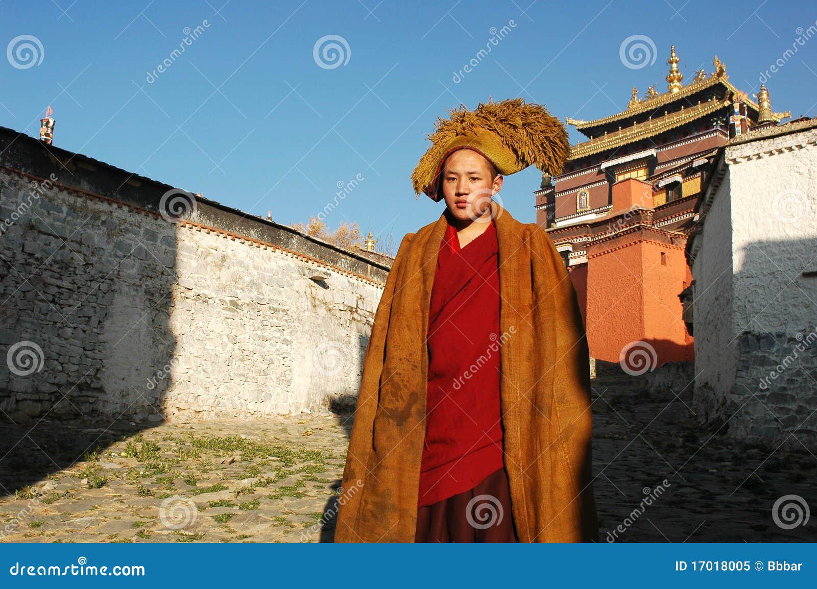Tibetan Monk In Traditional Red Robe On The Bridge Over The Thimphu Chu ...