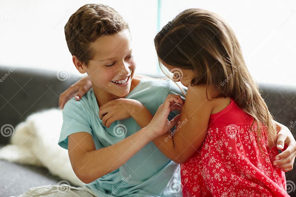 Tickle Fight A Brother And Sister Tickling Each Other While On The Sofa Stock Image Image Of