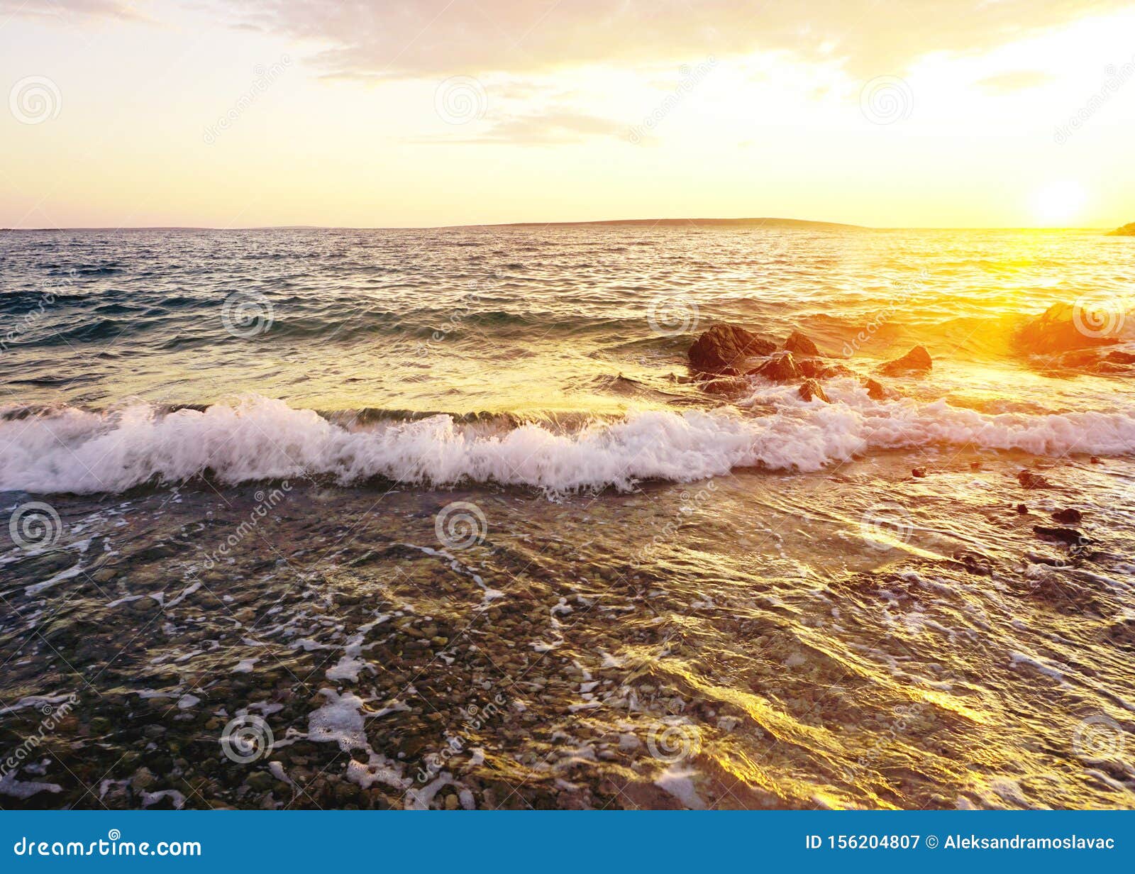 Tide and Waves on the Seacoast in the Evening Lit by Sunlight during ...