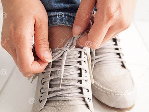 Tie a shoe string stock image. Image of jeans, hand, unrecognizable ...