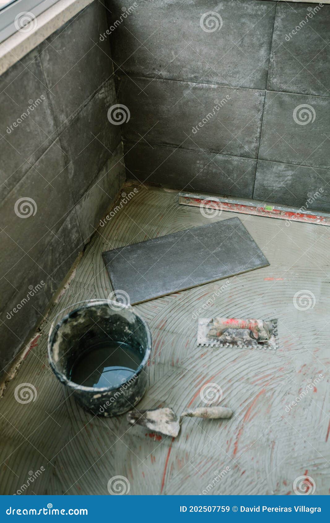 Tile laying work on floor stock image. Image of laying - 202507759