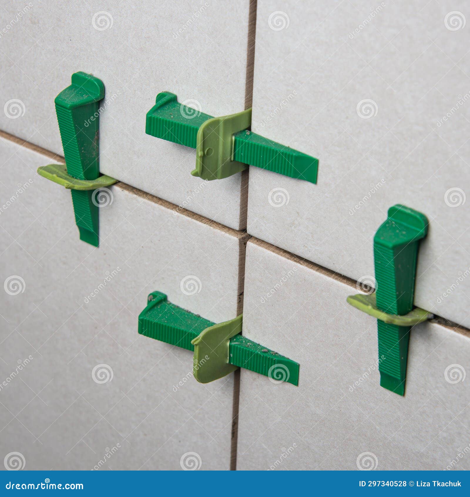Tile Leveling System with Plastic Clips and Wedges, Shot while the Tile ...