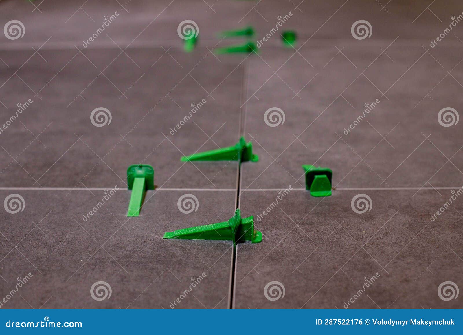 Tile Levelling System, Four Plastic Green Clips with Wedges. Close-up ...