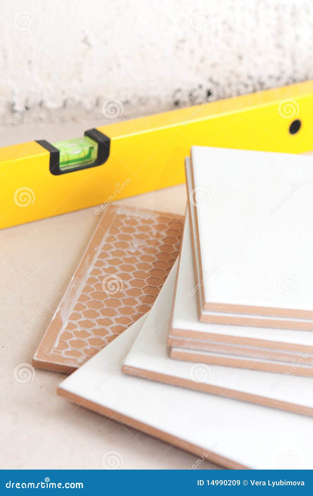 Tile and tool level stock image. Image of construction - 14990209