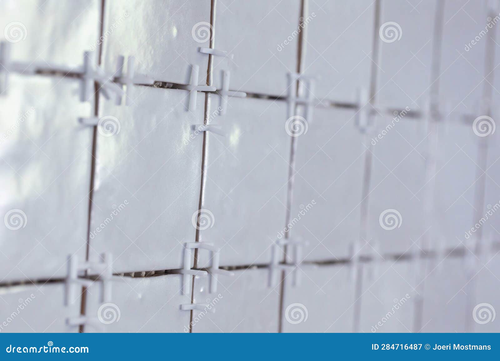 A Tile Wall Under Construction. the Wall is Being Tiled with Small ...