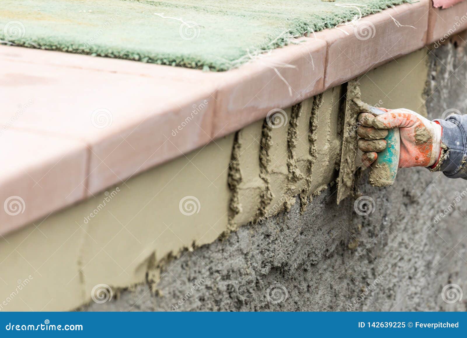 Tile Worker Applying Cement with Trowel at Pool Construction Site Stock ...