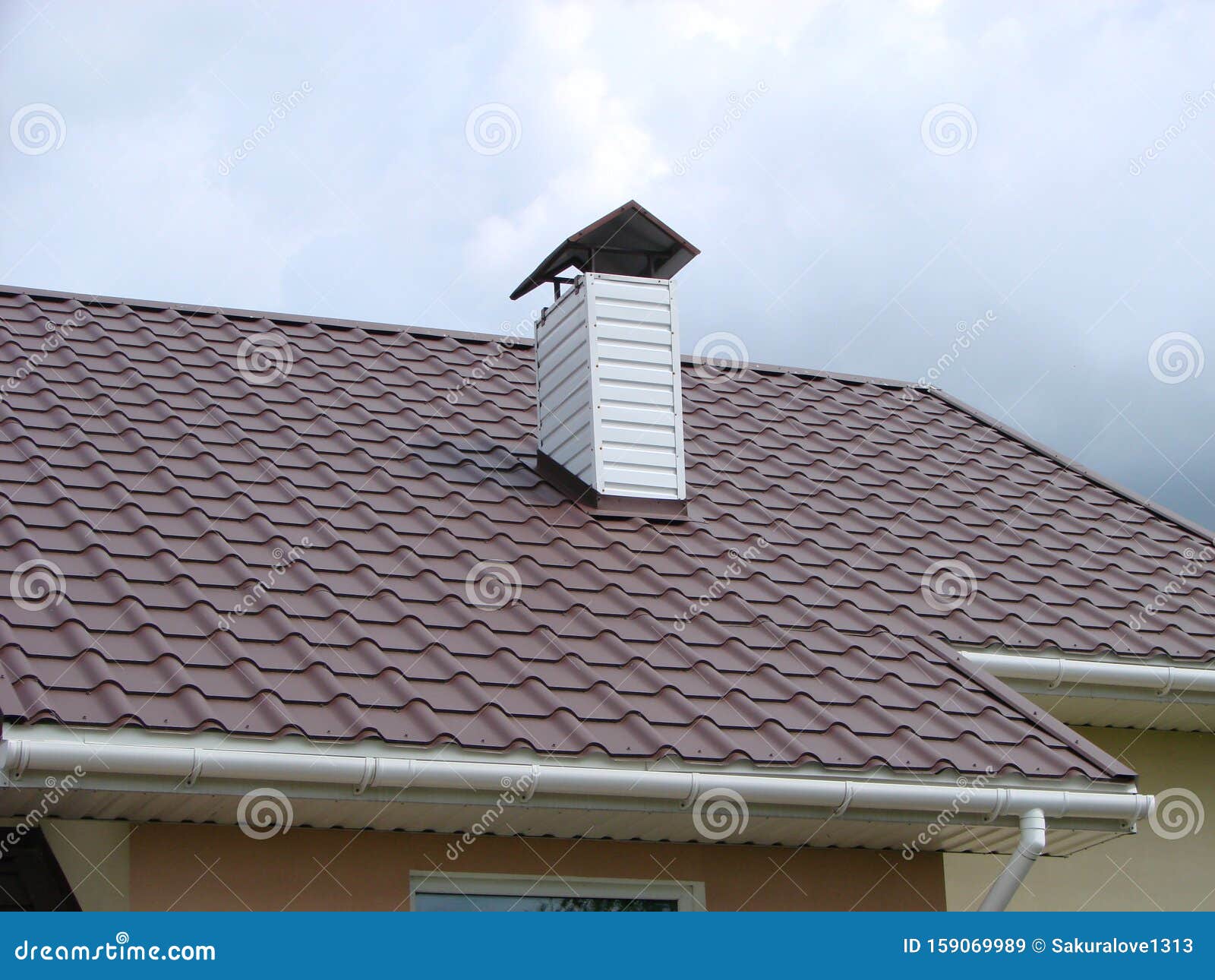 A Tiled Roof of a Building with a Wire Loop on it and Blue Sky at ...