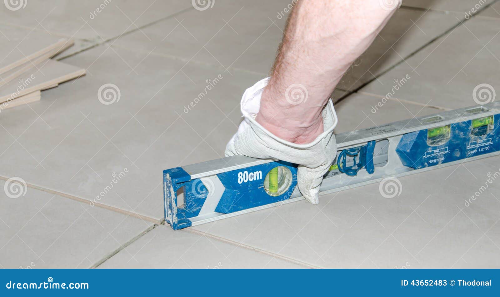 Tiler checking the level stock image. Image of measurement - 43652483