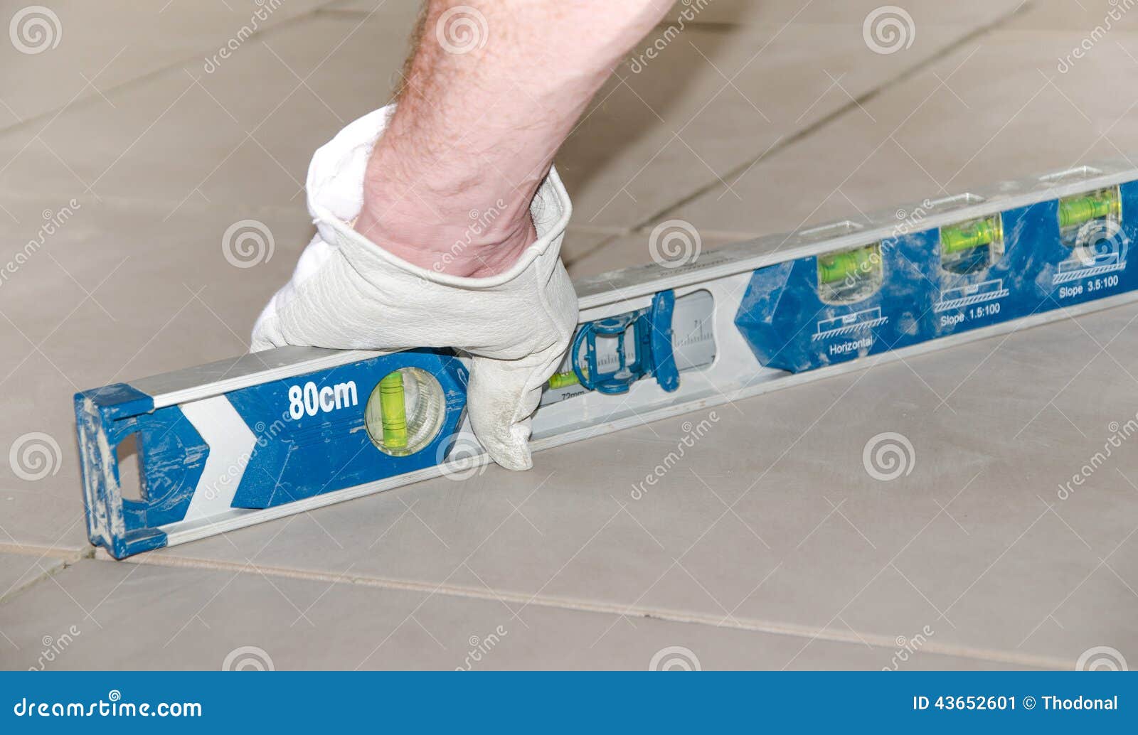 Tiler checking the level stock image. Image of repair - 43652601