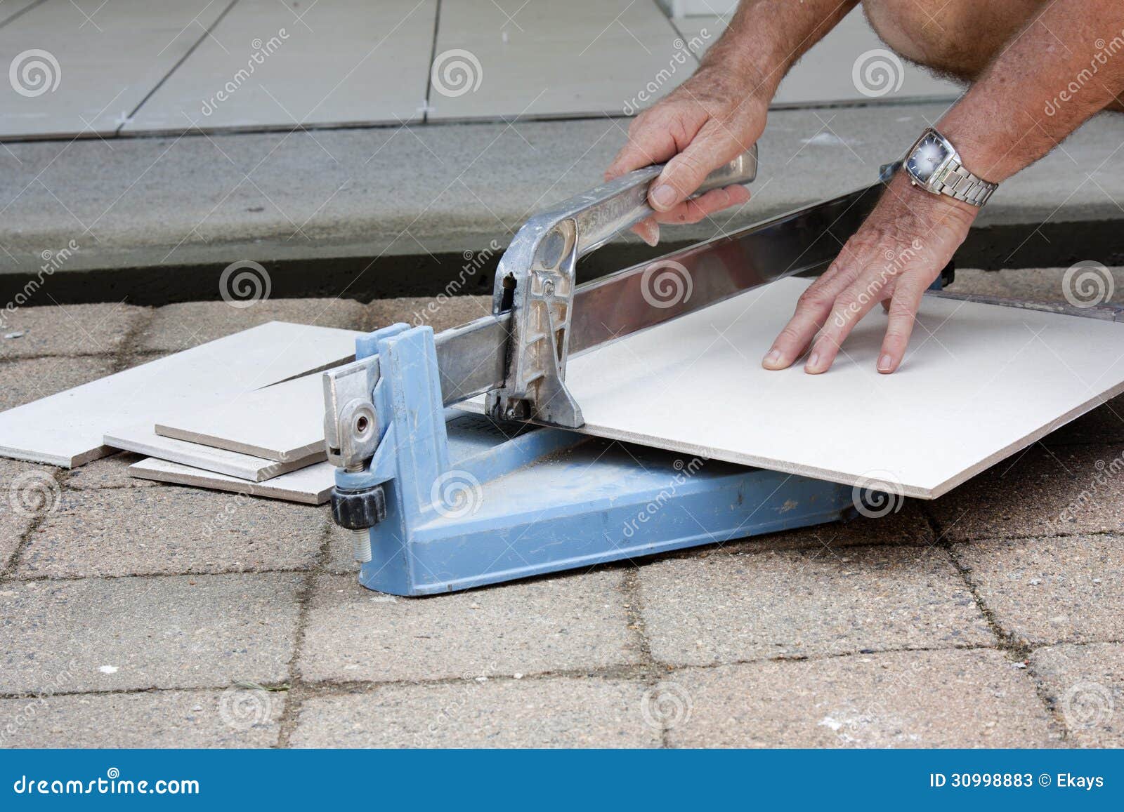 Tiler Cutting A Floor Tile With A Portable Angle Grinder. Craftsman ...