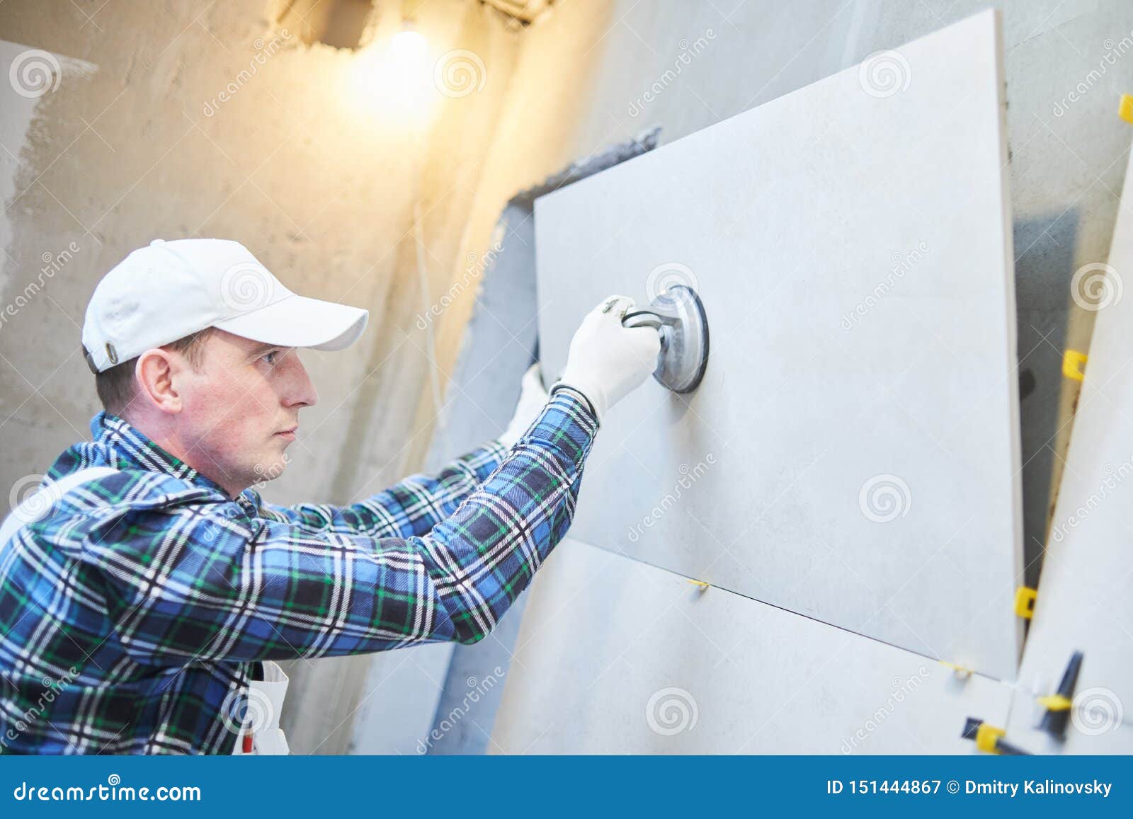 Tiler Installing Large Format Tile On Wall. Tile Leveling System Stock ...