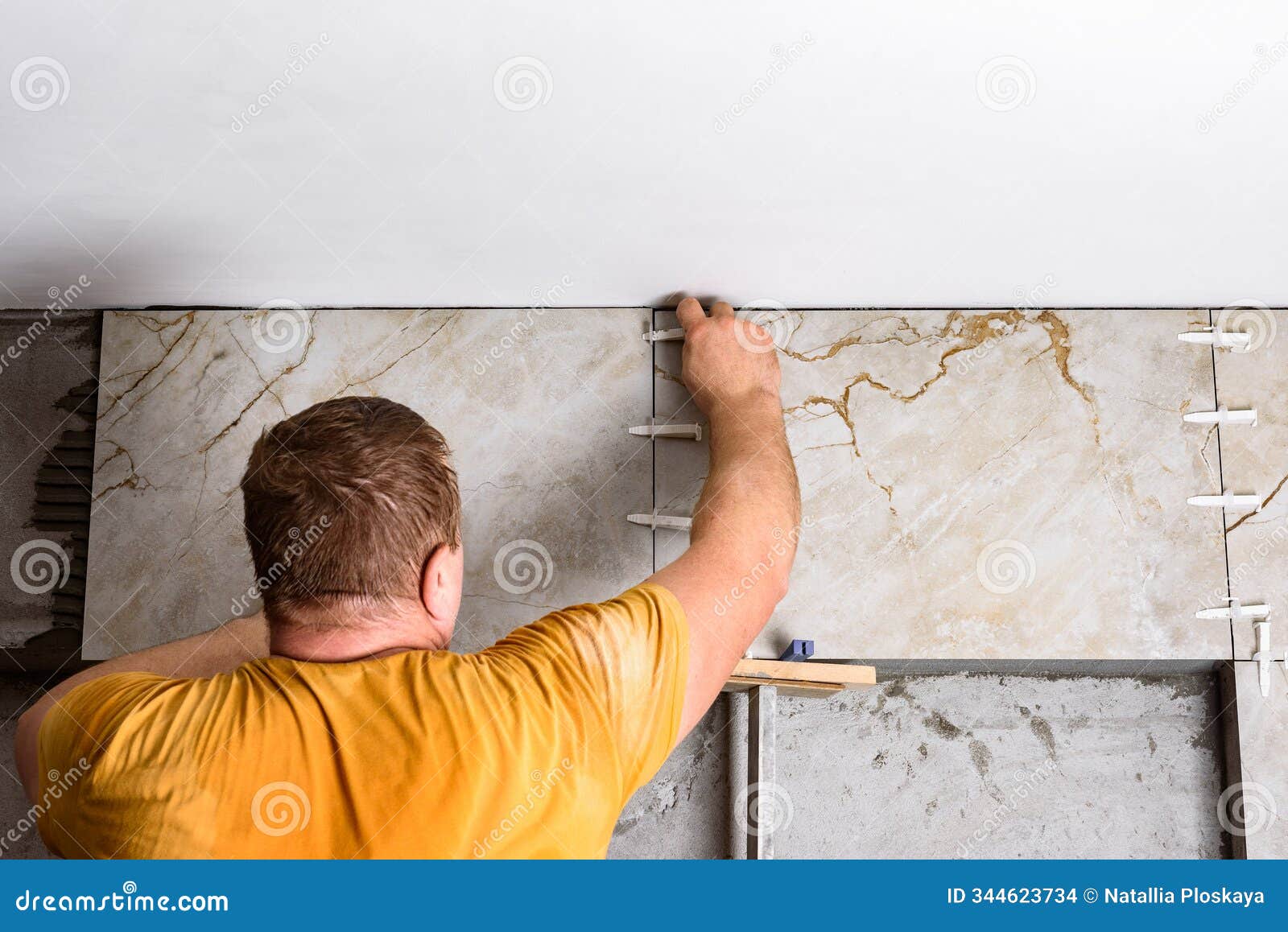 Tiler Installing Leveling System Tiles on Wall. Stock Photo - Image of ...