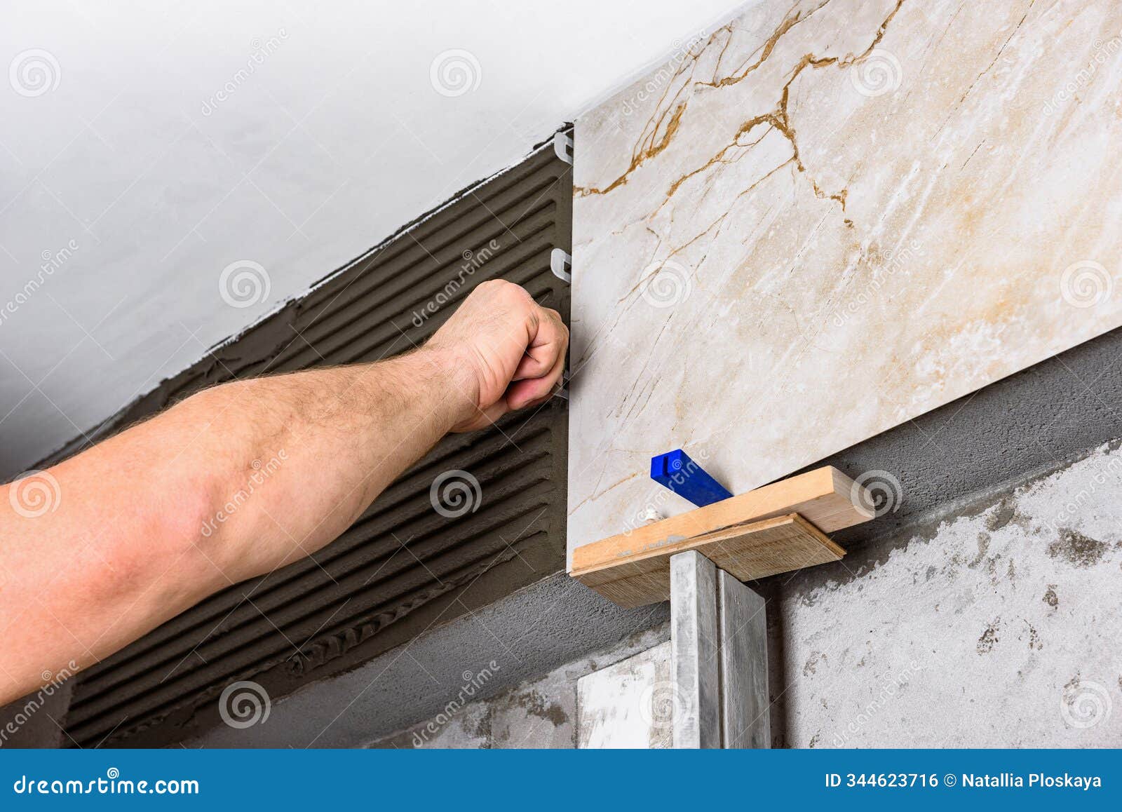 Tiler Installing Leveling System Tiles on Wall. Stock Photo - Image of ...