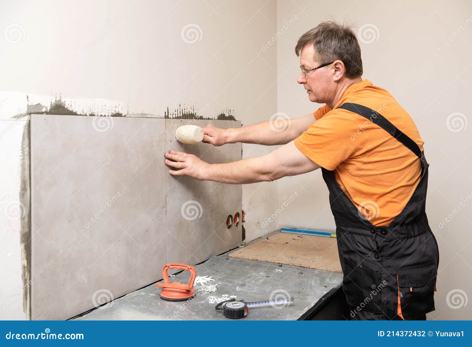 The Tiler is Installing the Tiles on the Wall Stock Photo - Image of ...