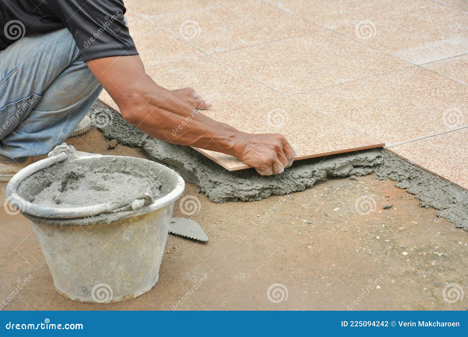 Tiler Placing Tile in Position Over Mixed Mortar for Tile Stock Photo ...