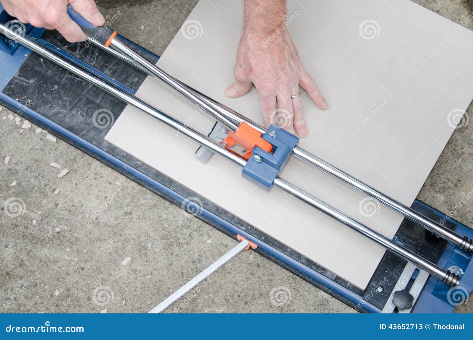 Tiler using a tile cutter stock image. Image of tiled - 43652713