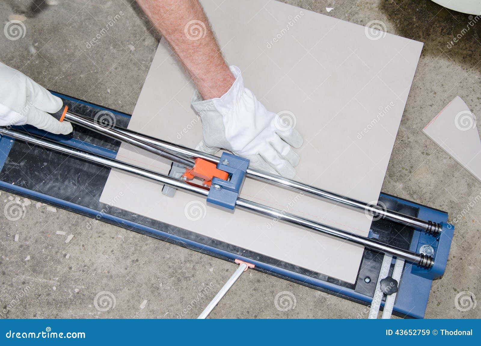 Tiler using a tile cutter stock image. Image of tiled - 43652759