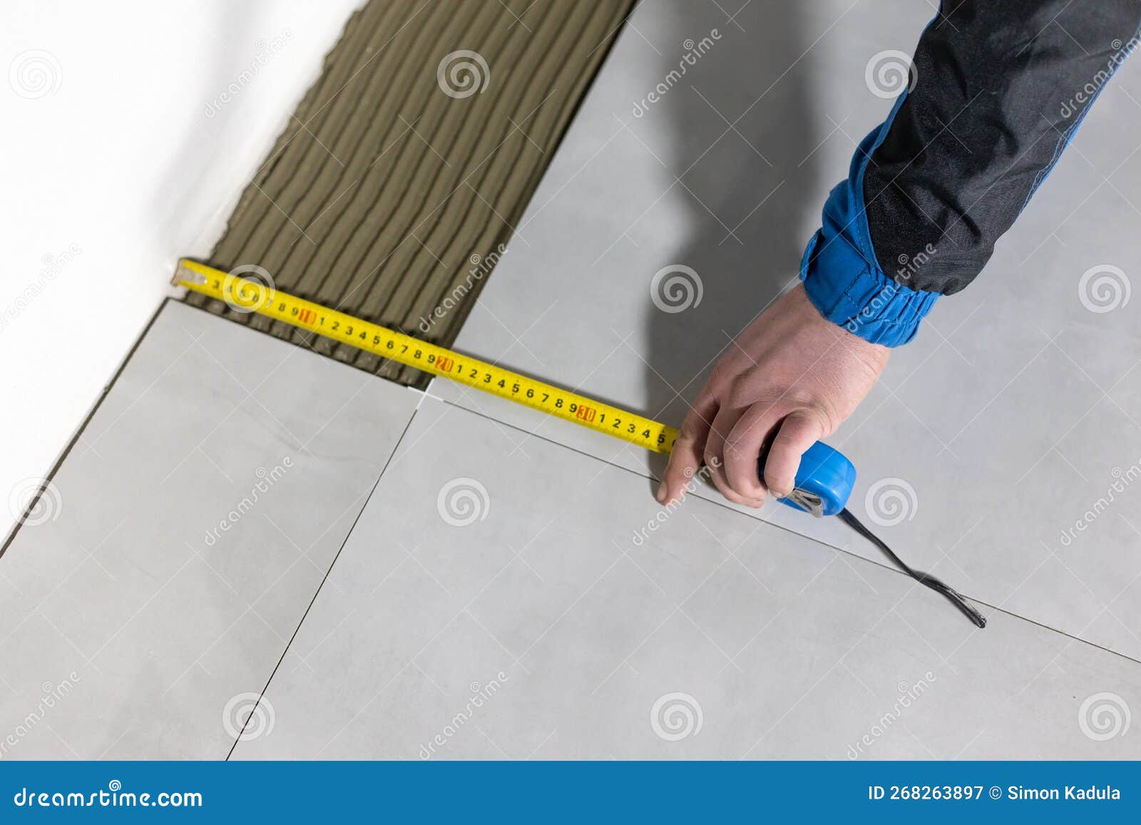 Tiler Worker Placing or Tiling Gray Ceramic Tile in the Position Over ...
