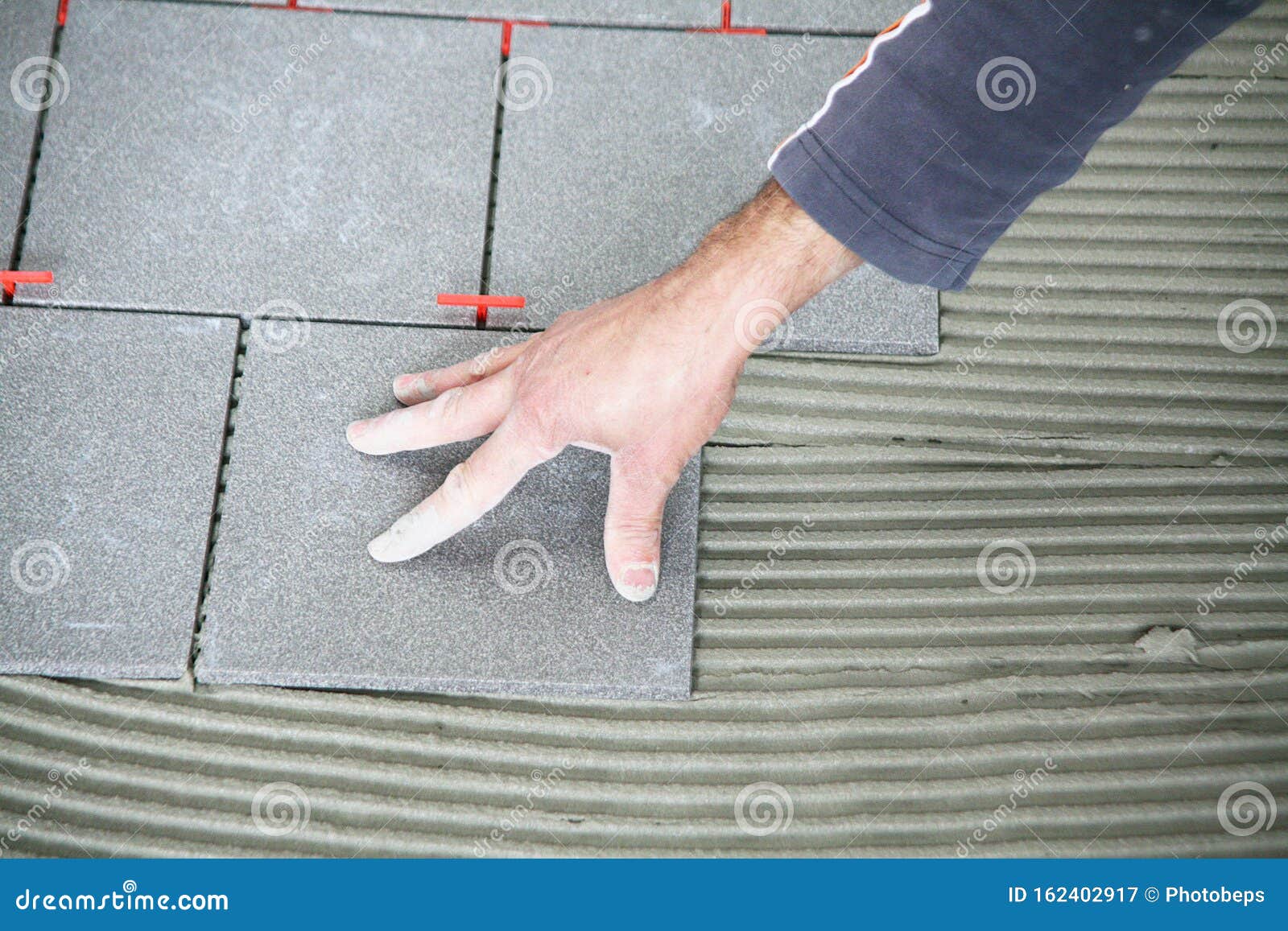 Tiler worker at work stock image. Image of building - 162402917