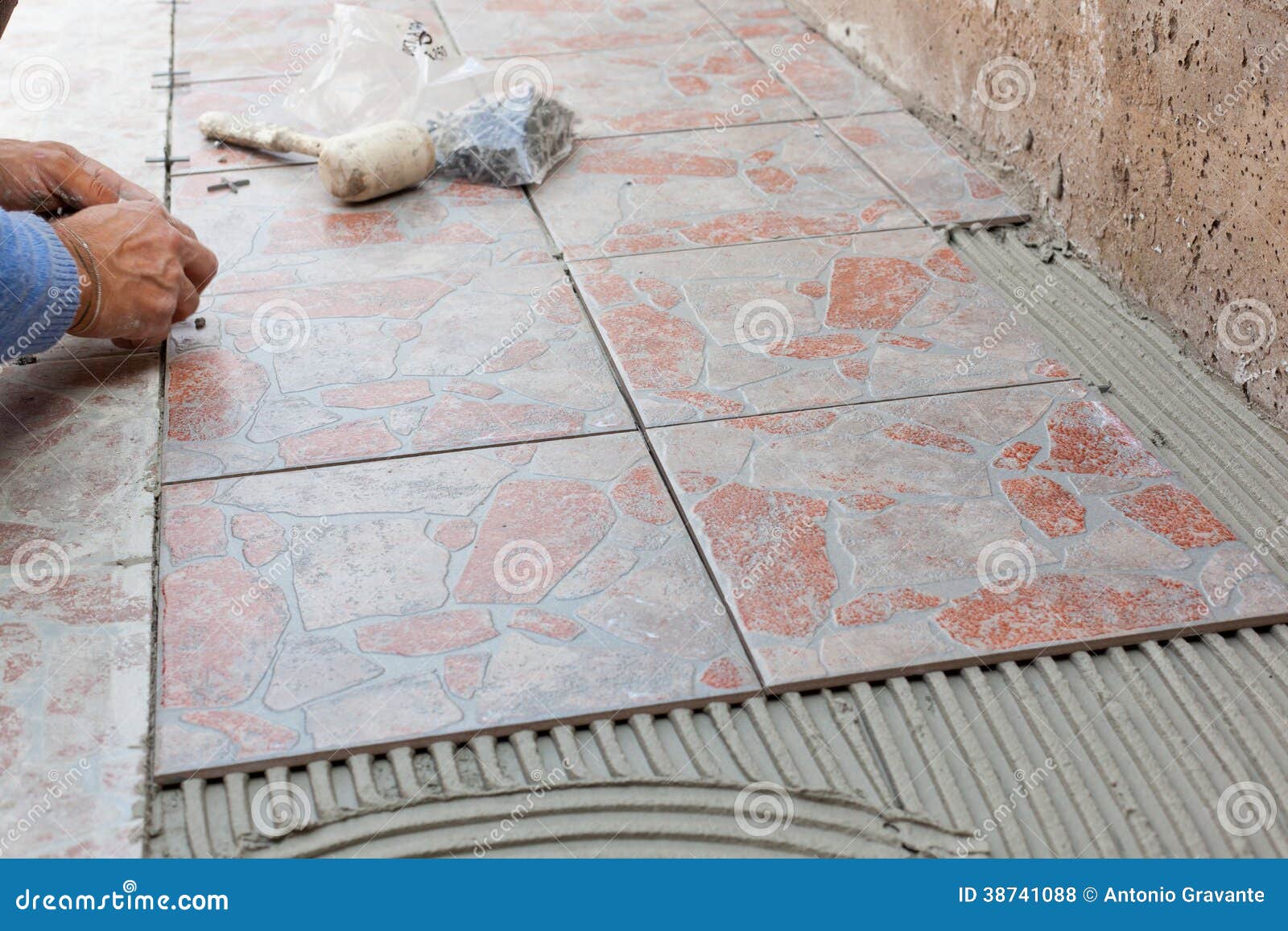 Tiler works with flooring stock photo. Image of area - 38741088