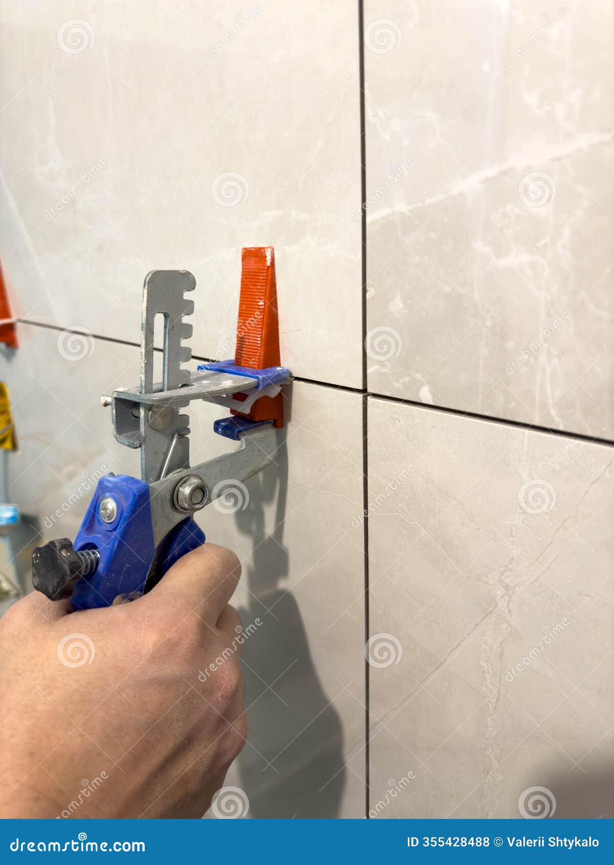 Tiling Process in Action with Manual Tile Leveling Tool Being Used ...