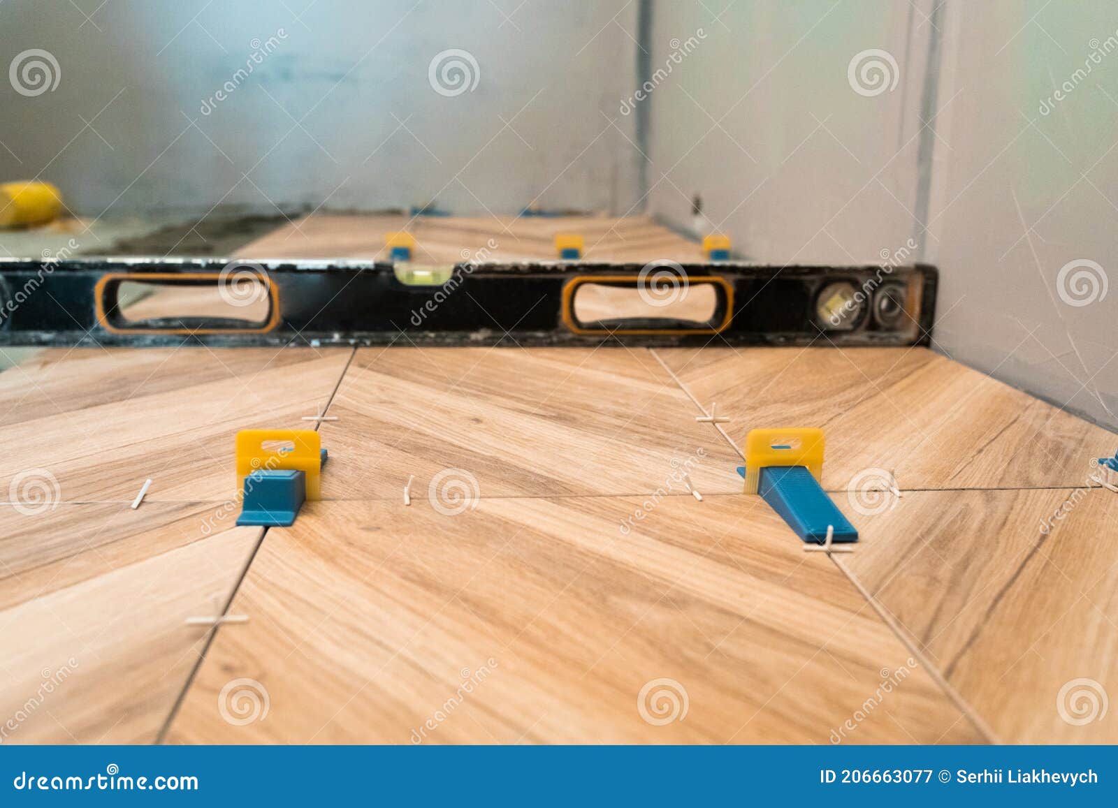 Tiling Work. the Man Checks the Level of the Correct Laying of the ...