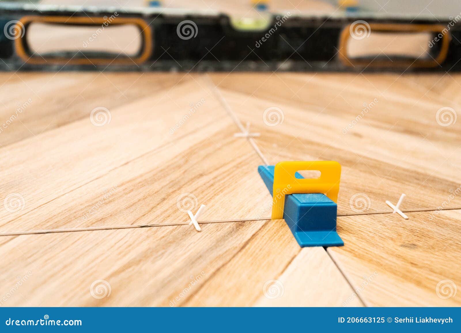 Tiling Work. the Man Checks the Level of the Correct Laying of the ...