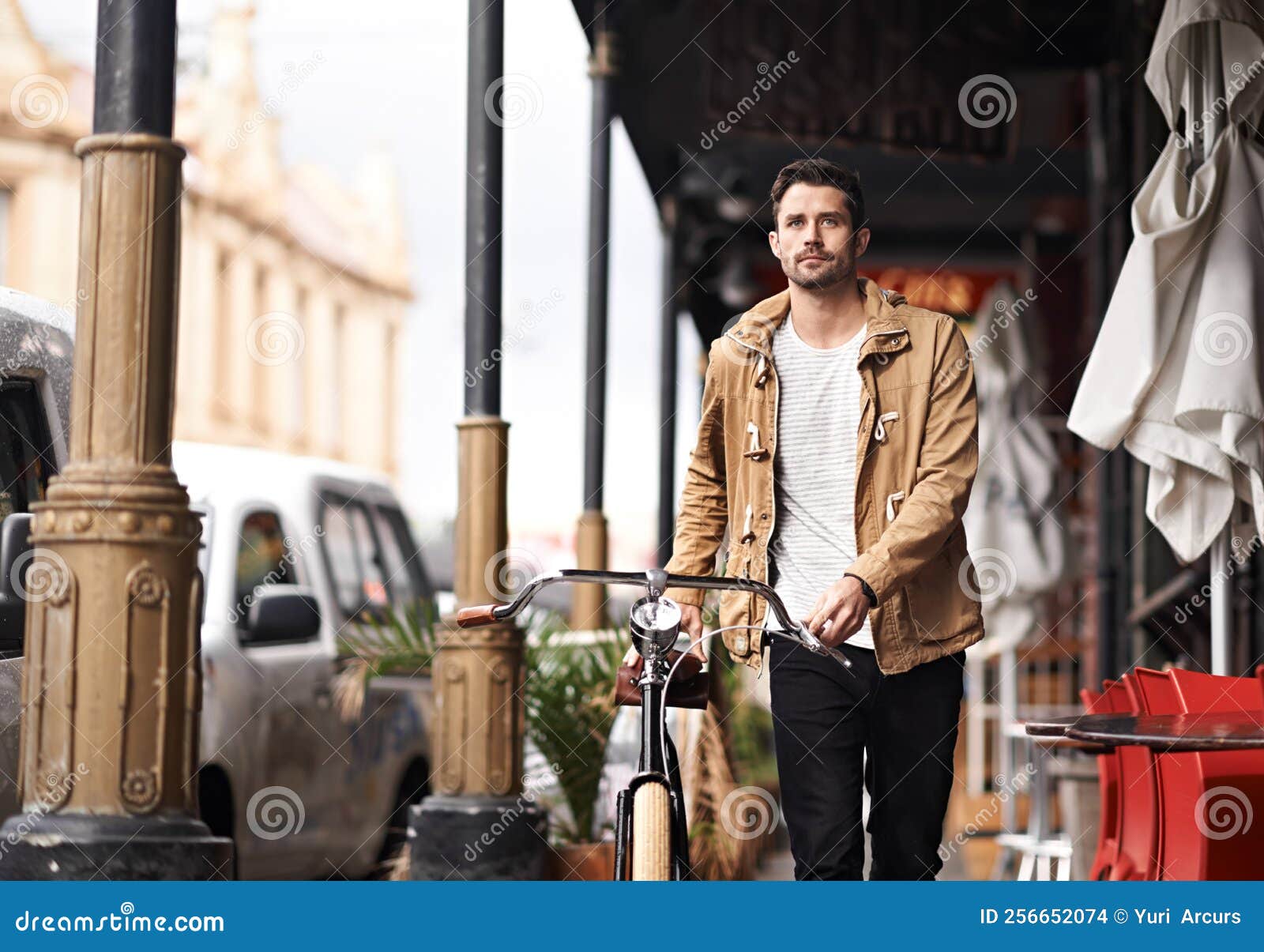 Time for a Cycle in the City. a Young Man Pushing His Bicycle through ...