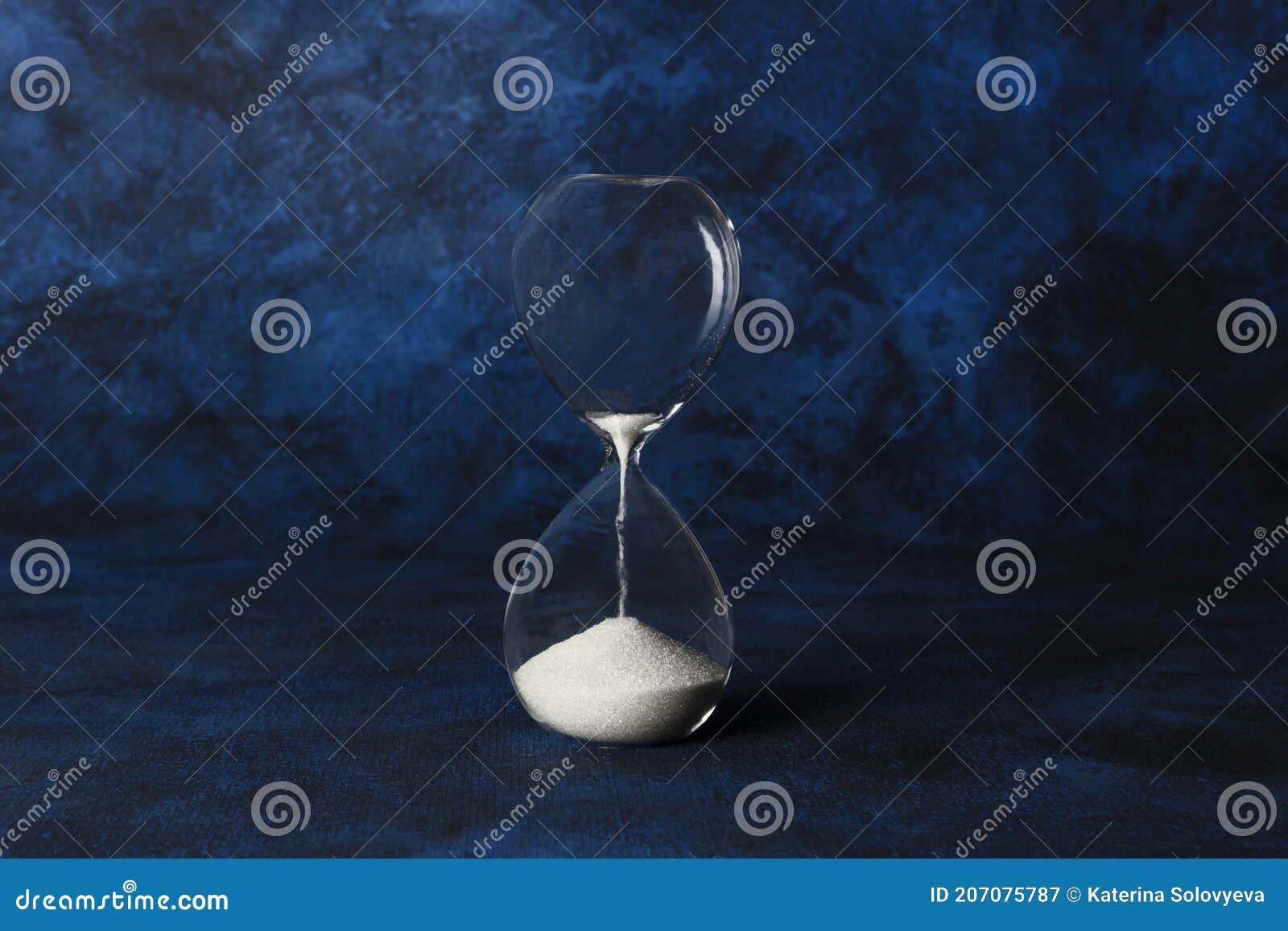 Time is Running Out Concept. an Hourglass with Sand Falling through, on ...