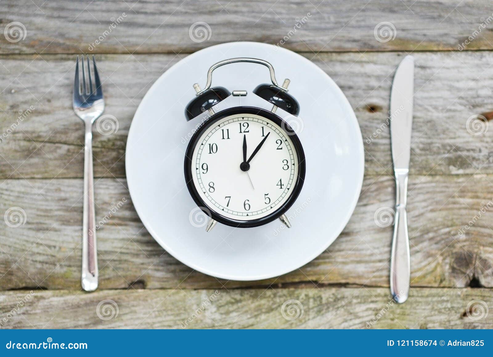 Time To Eat with Clock Plate Fork and Knife on a Table Stock Photo ...