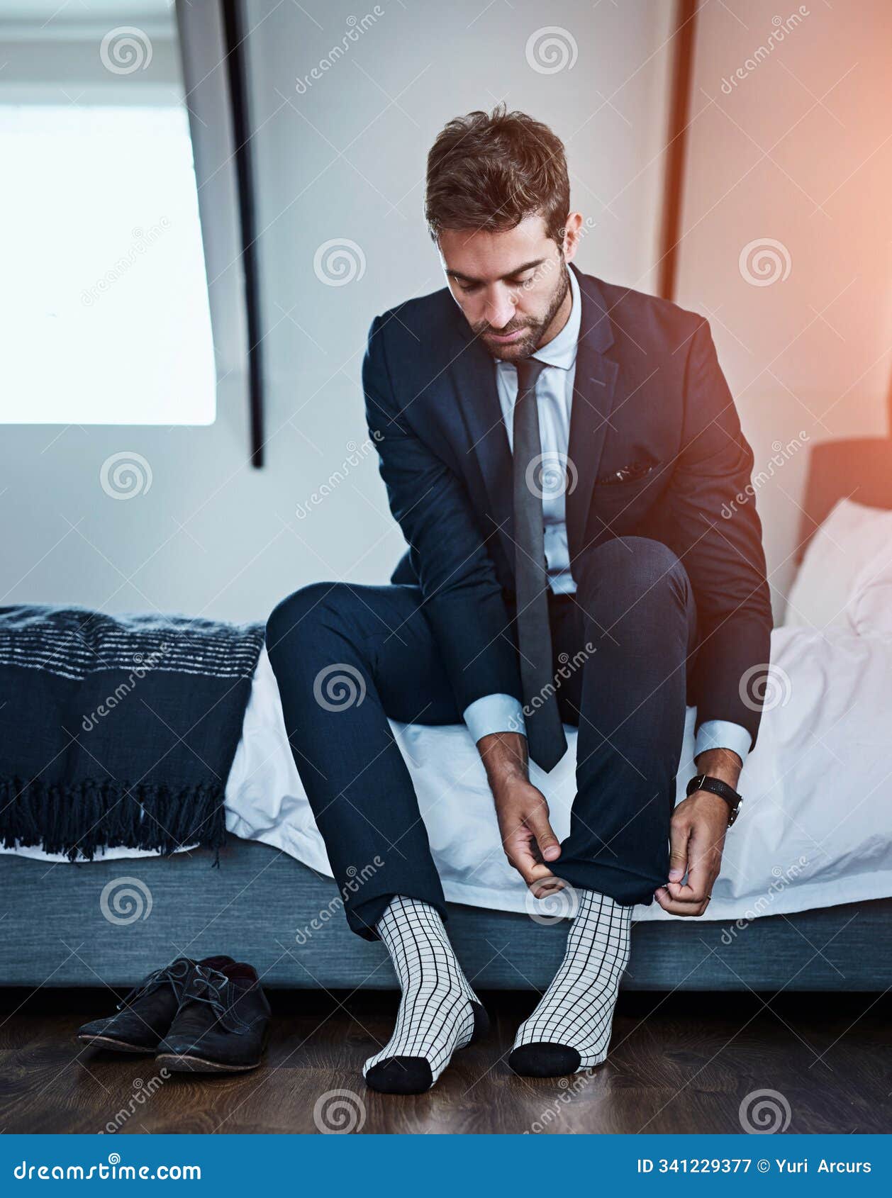 Time To Get the Day Started. Shot of a Handsome Young Man Dressing ...