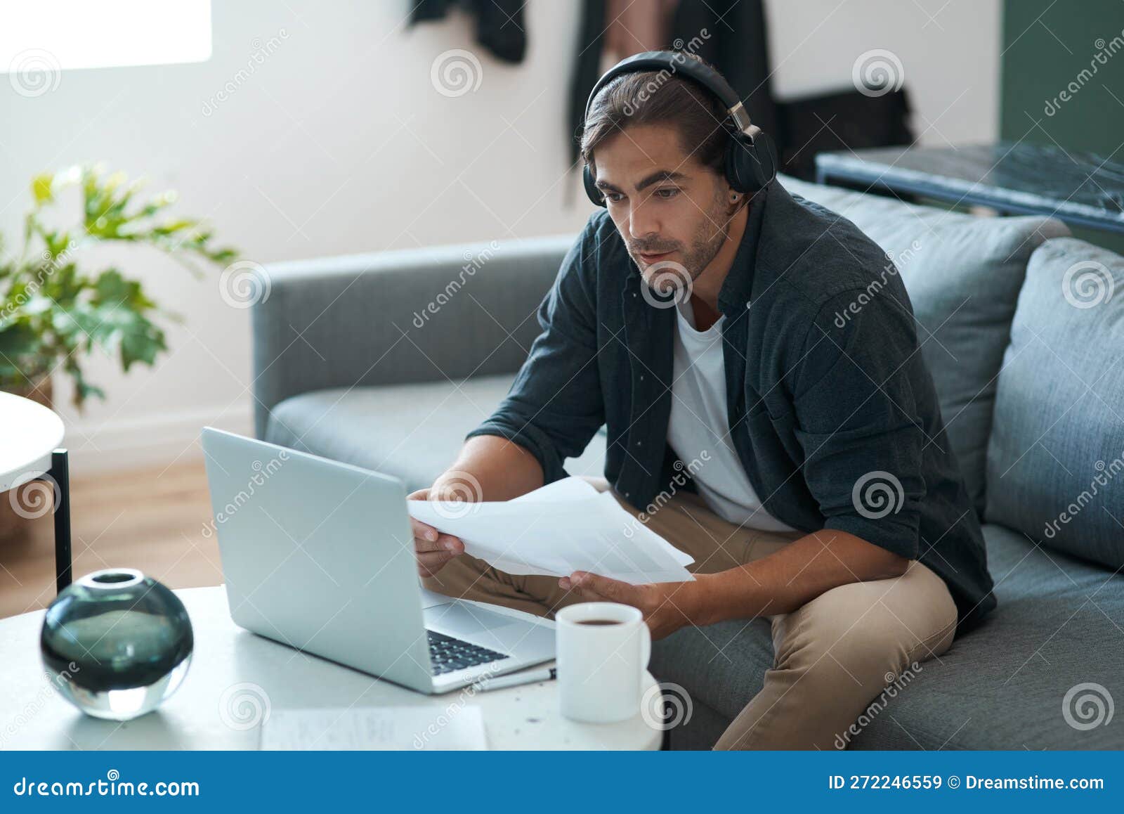 Time To Put in the Work. a Young Man Doing Paperwork while Using a ...